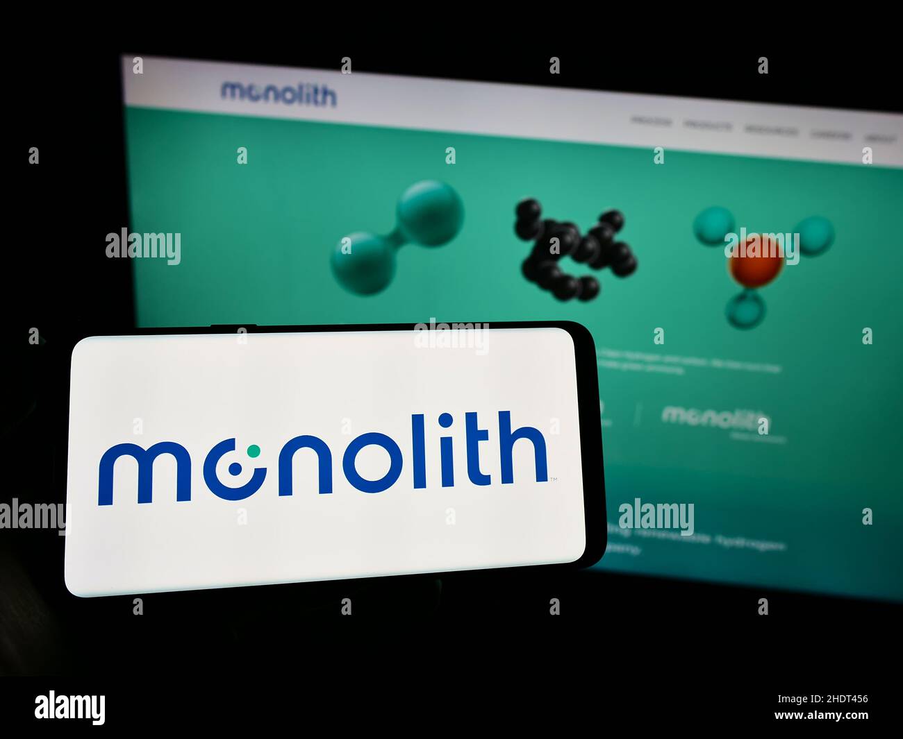 Person holding mobile phone with logo of American hydrogen company ...