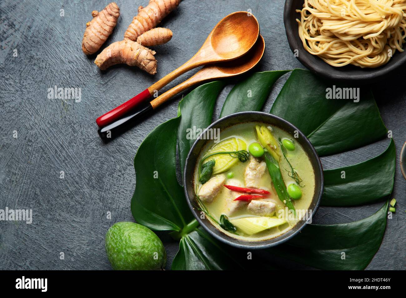 Green curry with chicken in bowl on dark background. Traditional Asian ...