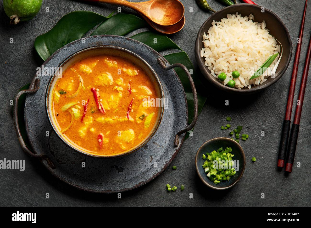 Yellow curry with chicken in bowl on dark background. Traditional Asian ...