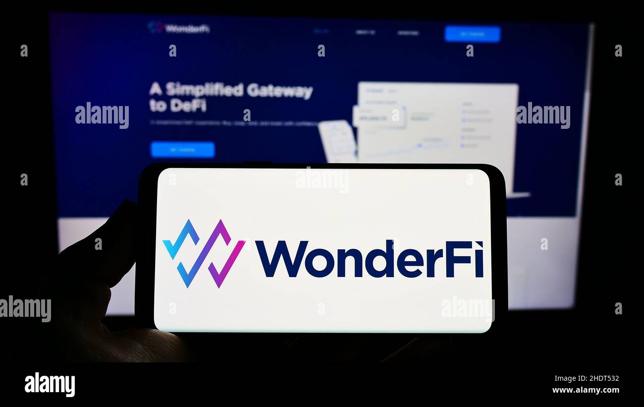 Person holding mobile phone with logo of Canadian fintech company ...