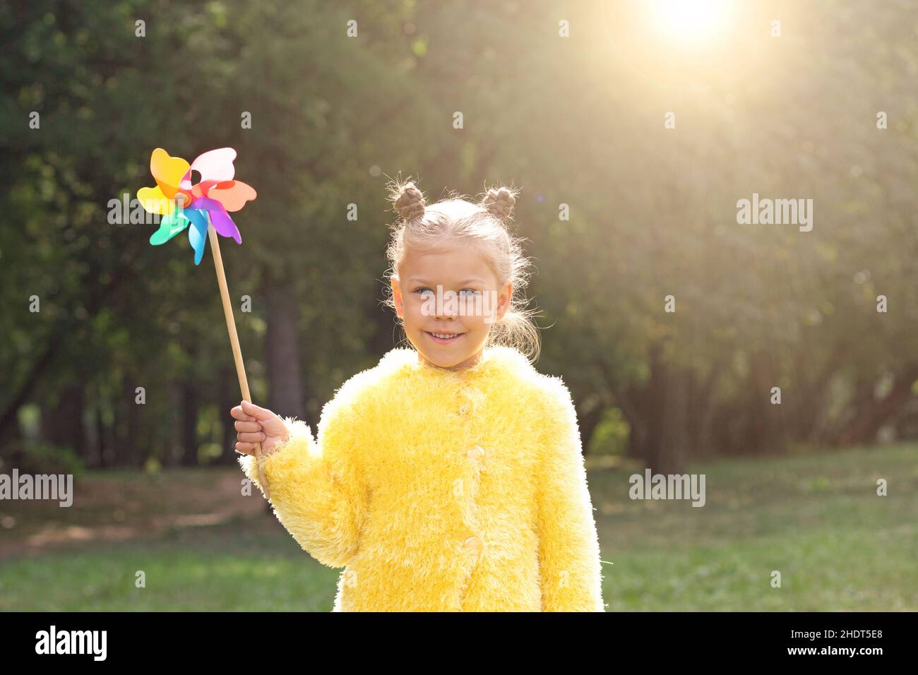 Beautiful child with pinwheel in park Stock Photo - Alamy
