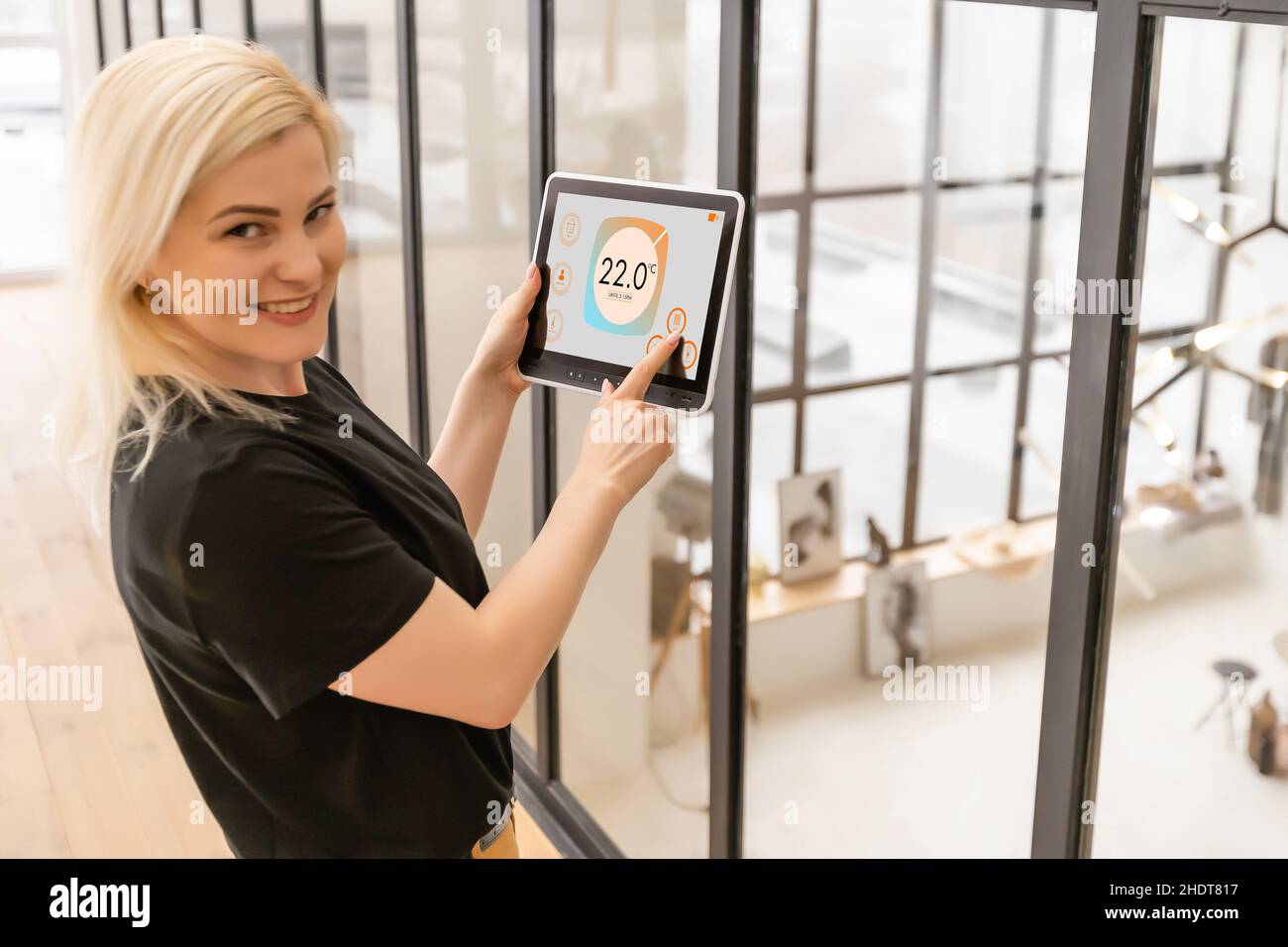Female hands hold a tablet computer with system clever house on a ...