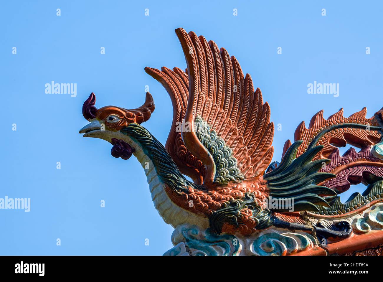 Painted phoenix statue on the roof of traditional Chinese ancient ...