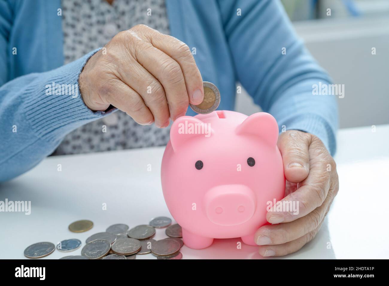 Asian senior or elderly old lady woman holding counting coin money in ...