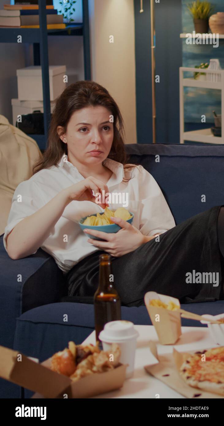 Woman laying on couch eating hi-res stock photography and images - Alamy