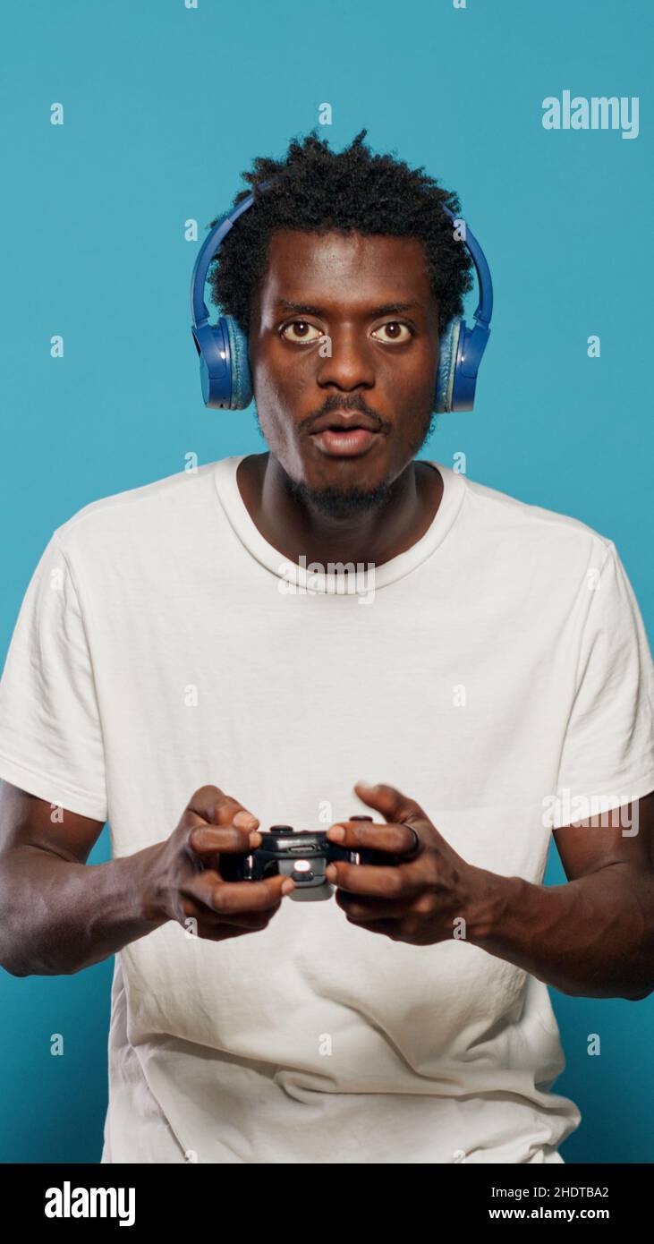 African american gamer playing video games with controller and ...
