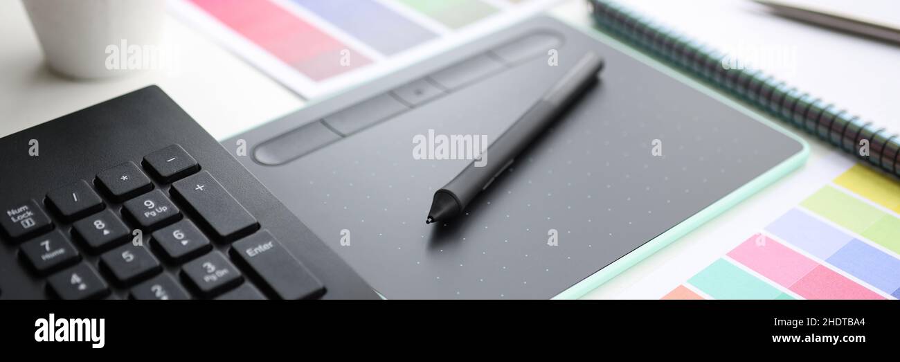 Graphic tablet stylus and color palette on table Stock Photo - Alamy