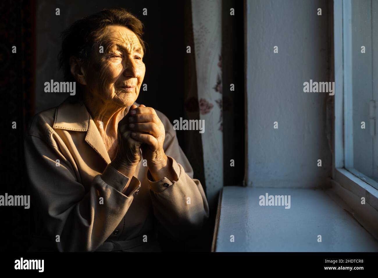 Close up portrait of an old woman praying Stock Photo - Alamy