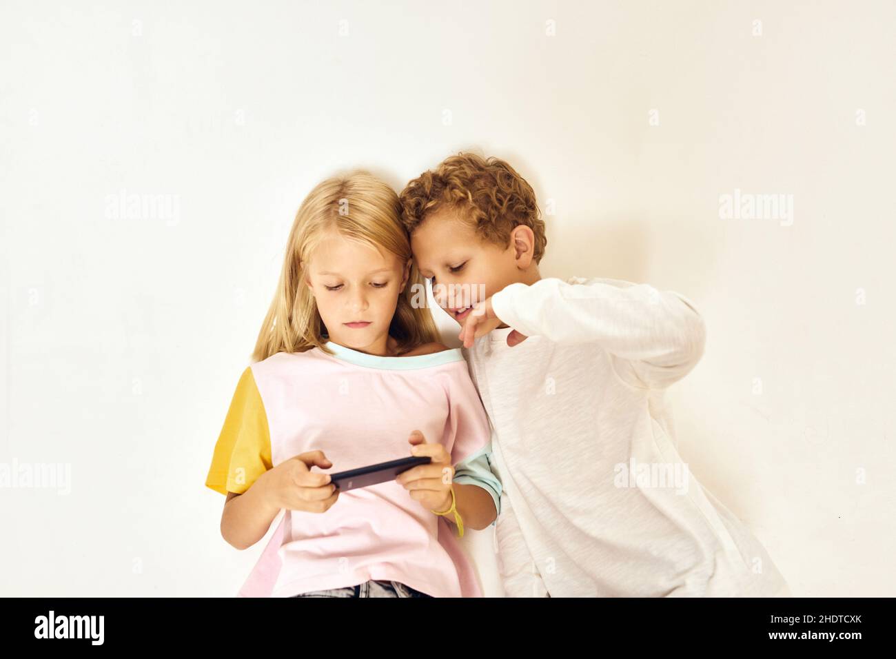 children looking at the phone technology light background Stock Photo ...