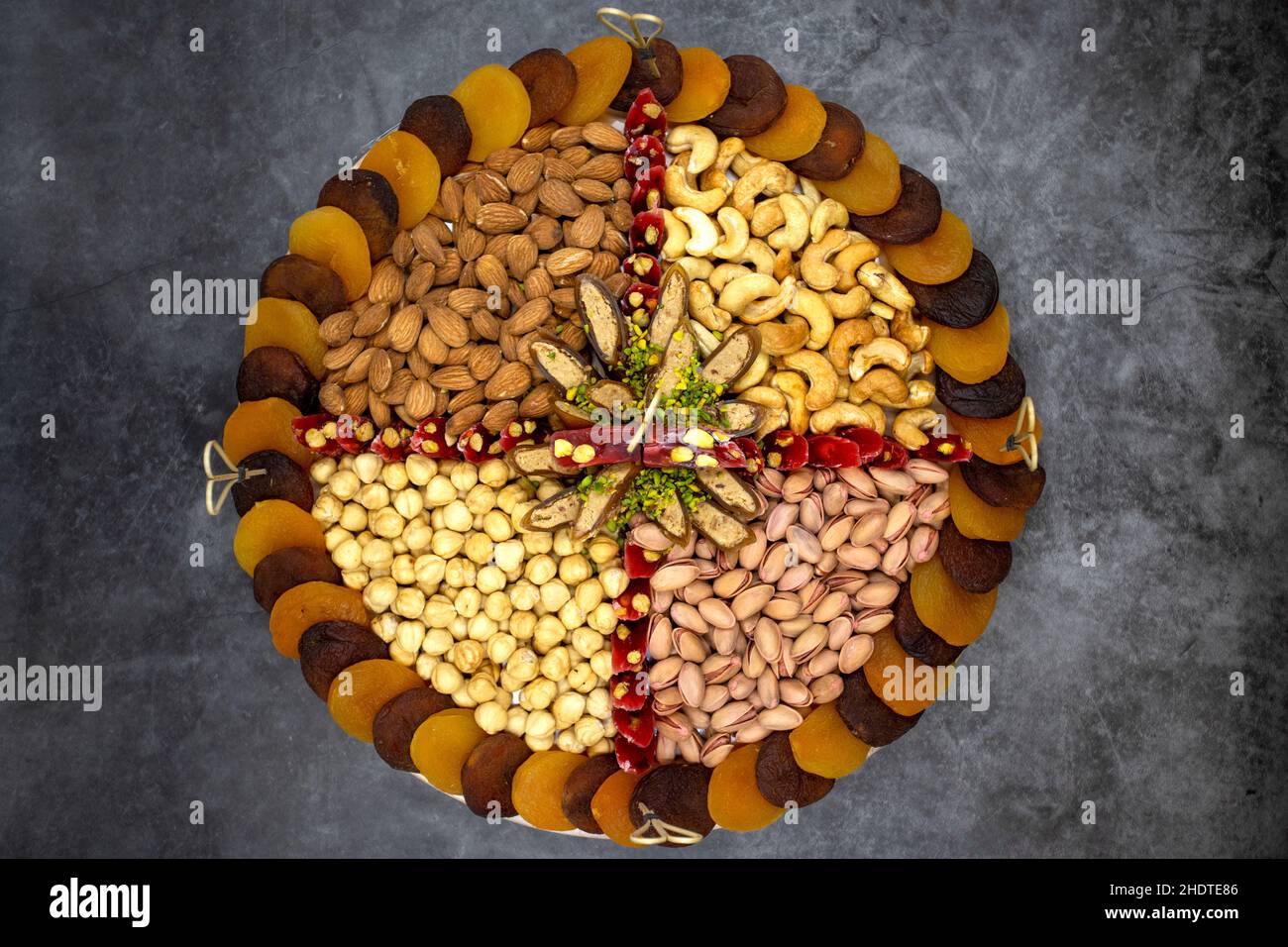 mixed nuts plate on dark background. Snack plate prepared with ...