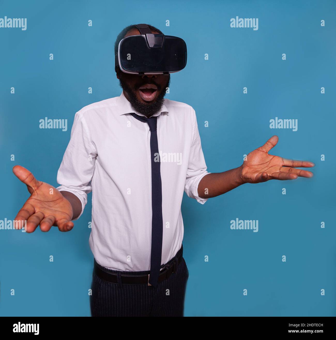 Portrait of surprised man wearing virtual reality goggles having ...