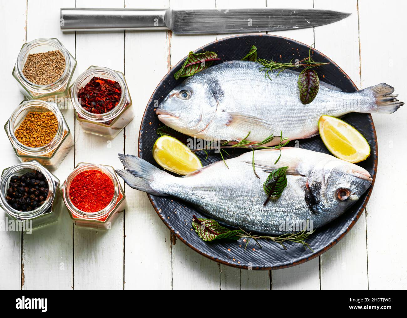 Fresh fish, dorado and spices. Raw dorado, or sea carp Stock Photo - Alamy