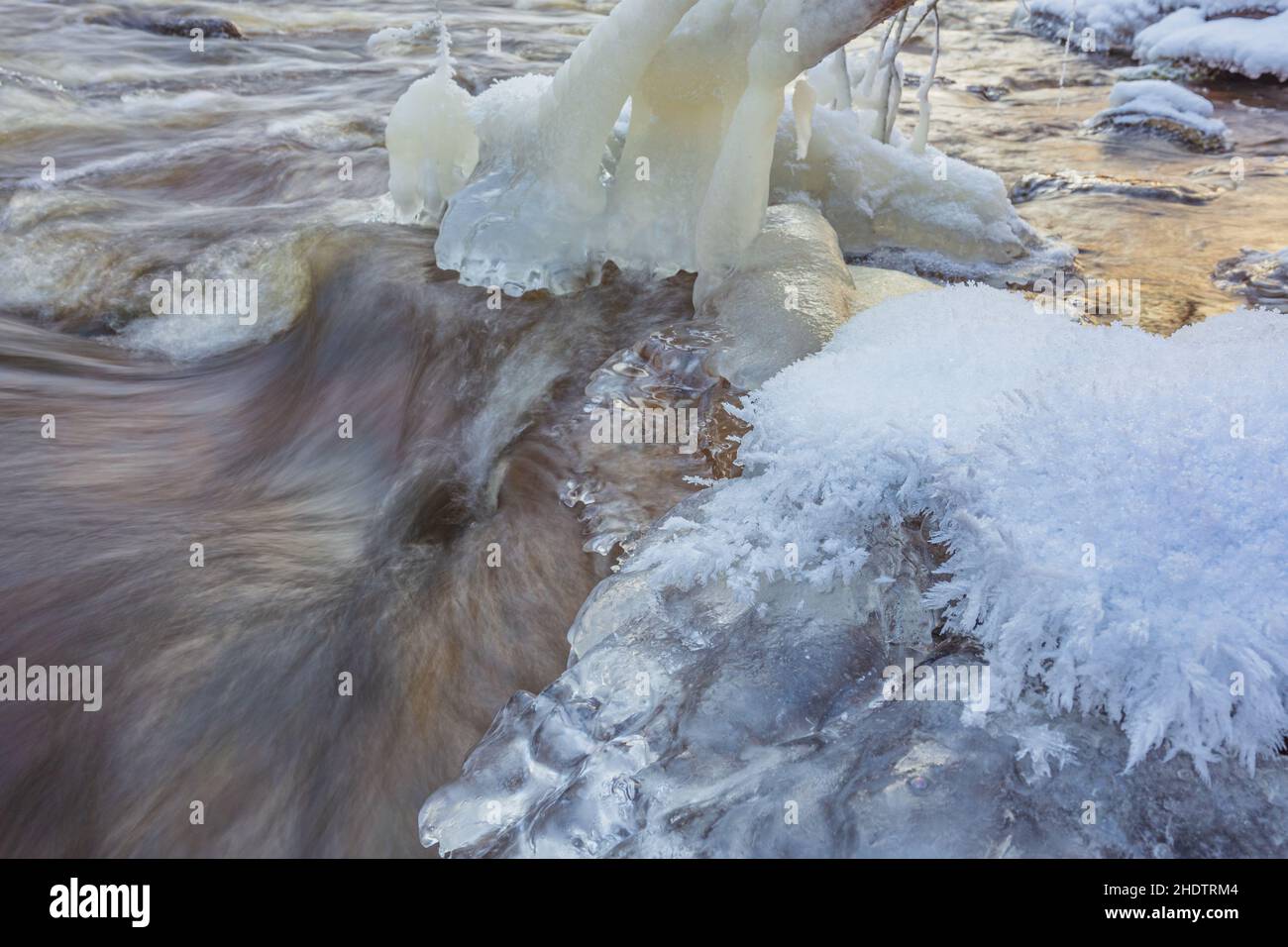 Icicles over the water in the river. Natural landscape. Winter ...