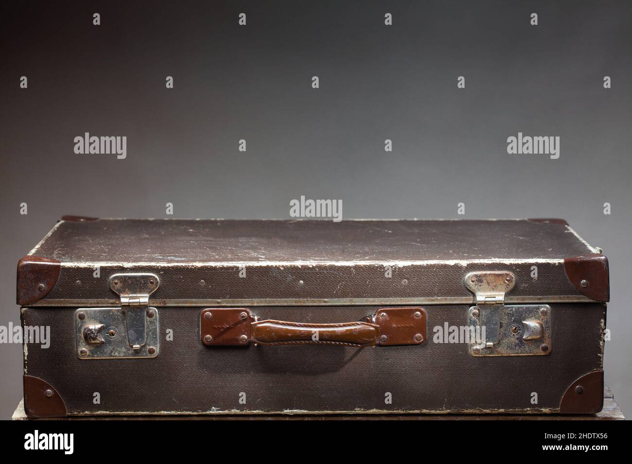Old vintage suitcase on wooden table on blank gray background Stock ...