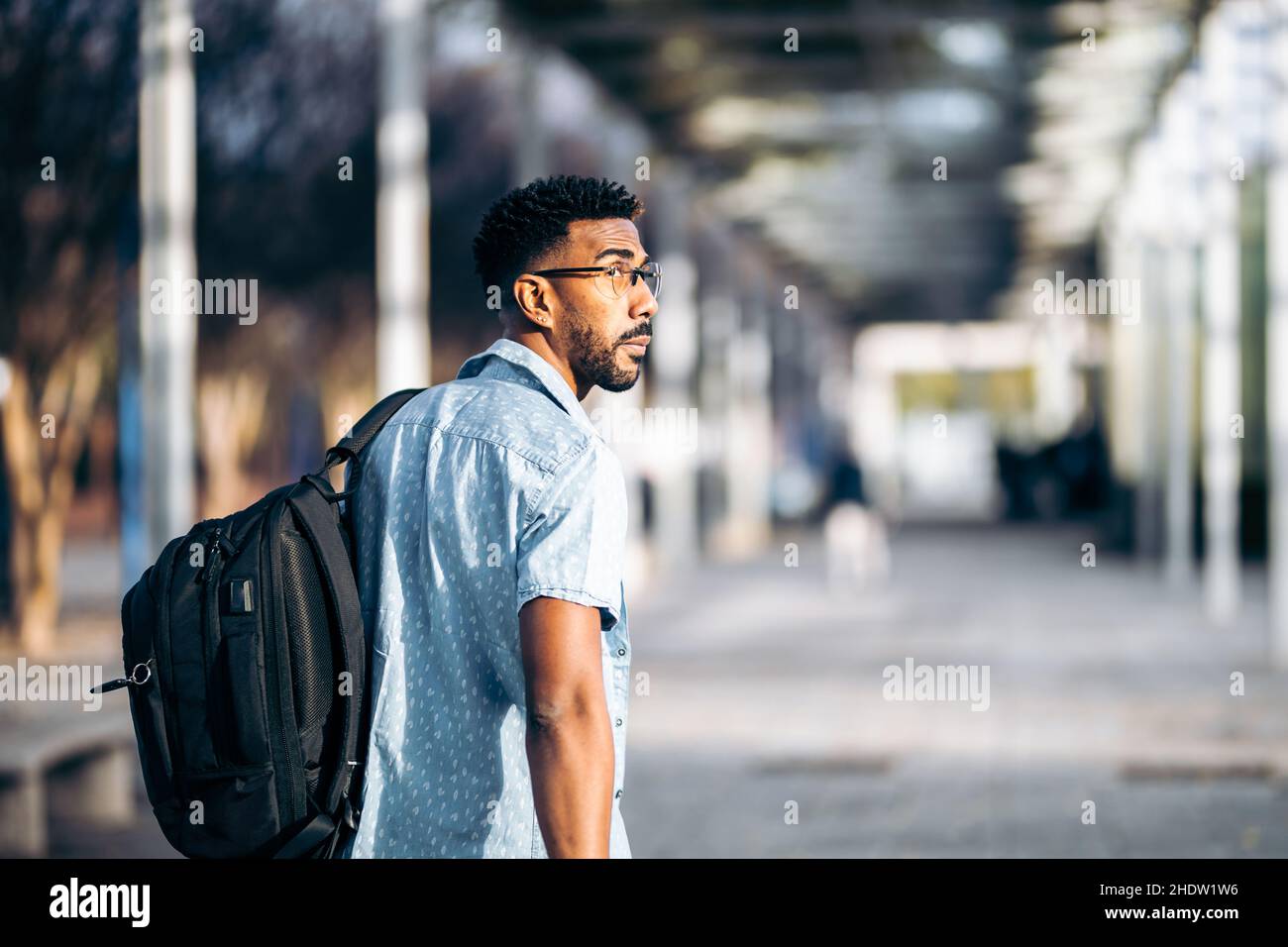 Black student man with glasses and backpack from behind Stock Photo - Alamy