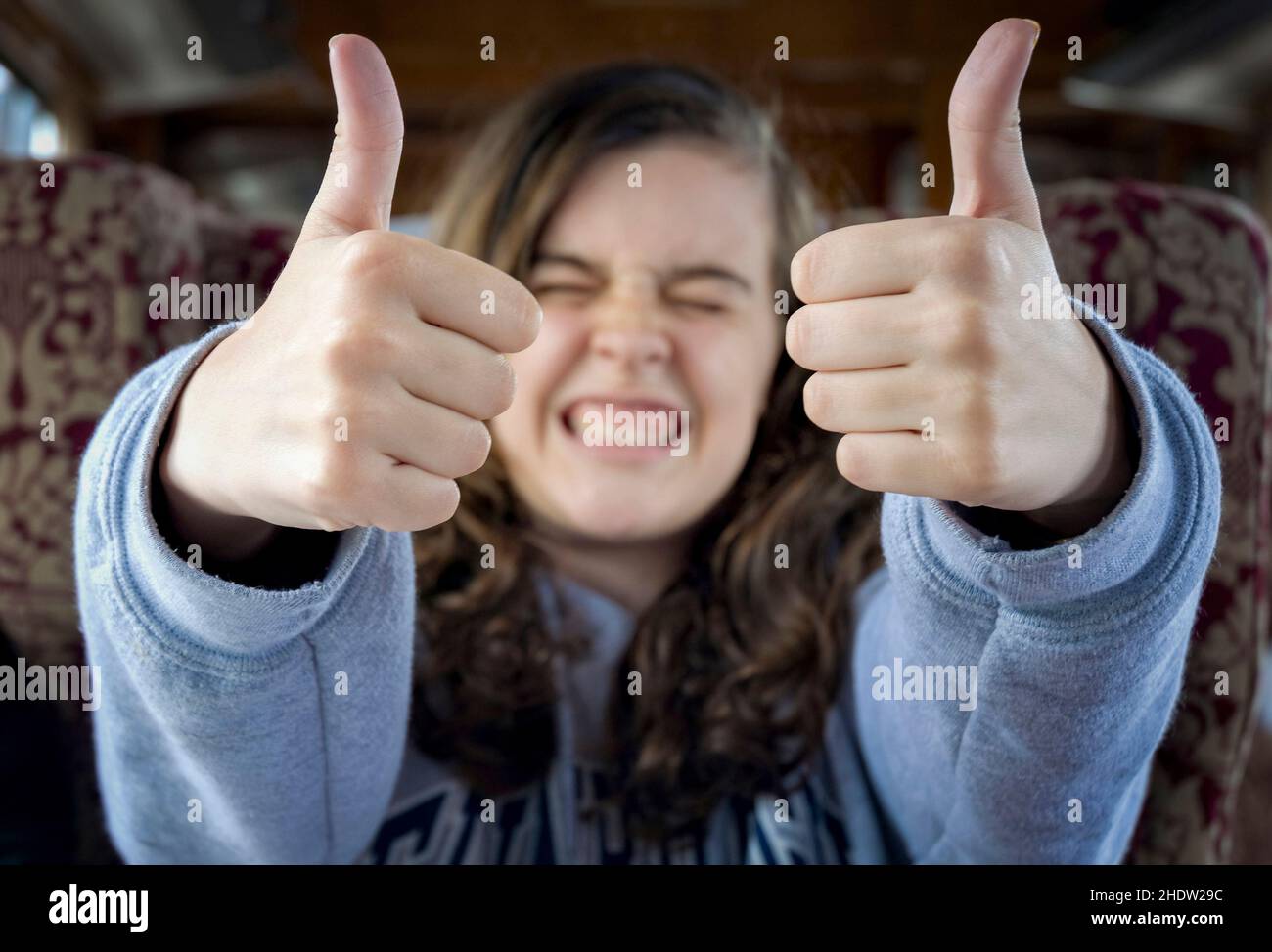 Long-haired teenage girl with her face out of focus in the background ...