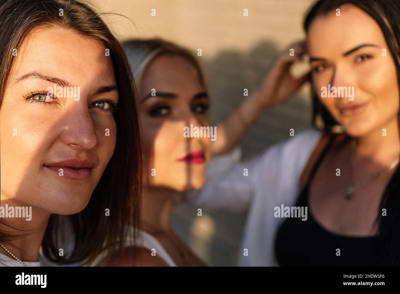Three women posing camera hi-res stock photography and images - Alamy