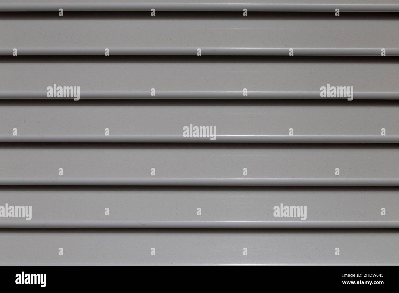perpendicular view of an aluminum shutter with gray painted strips ...
