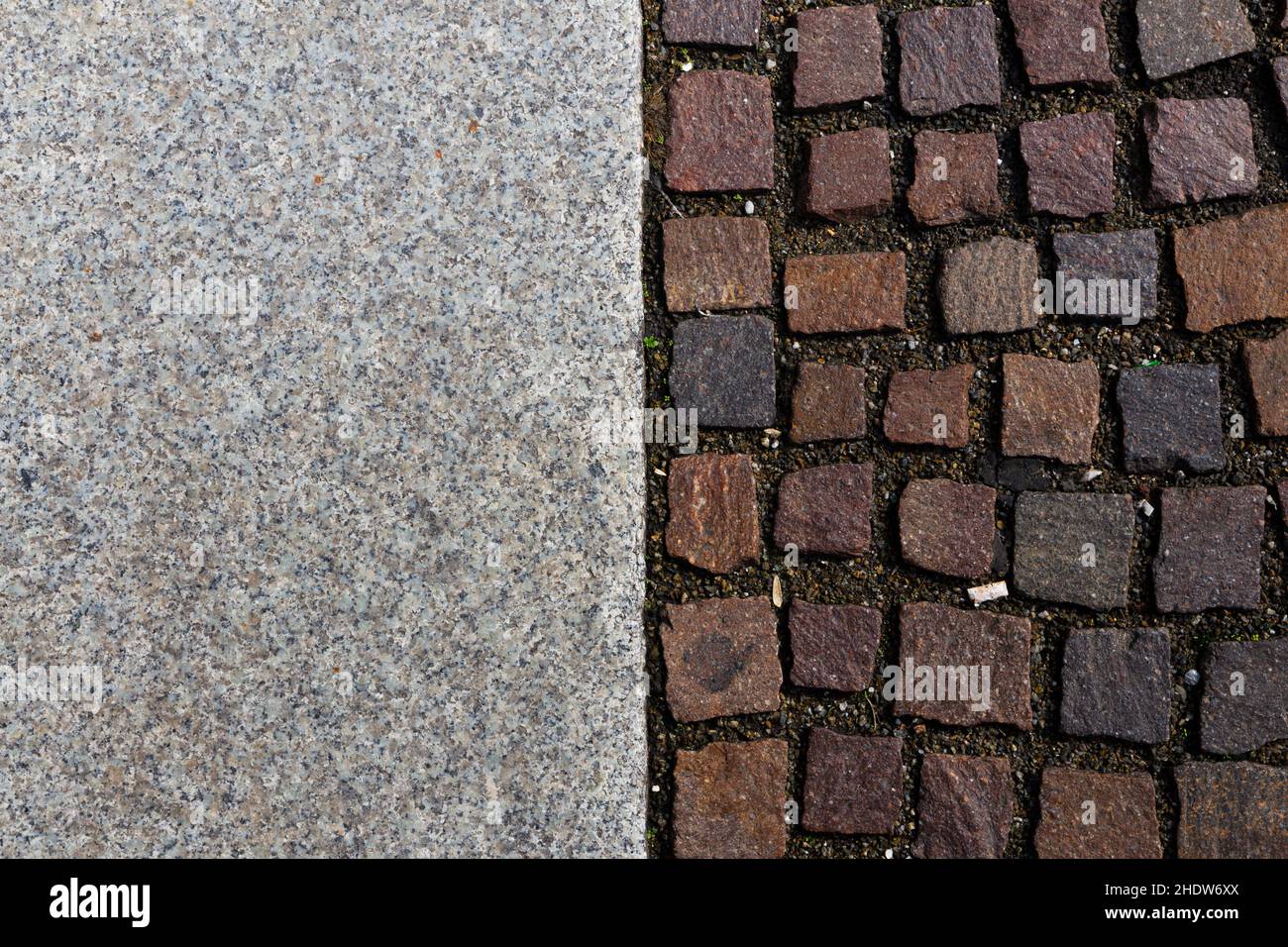 perpendicular view of a pavement of porphyry tiles and stone slabs in a ...