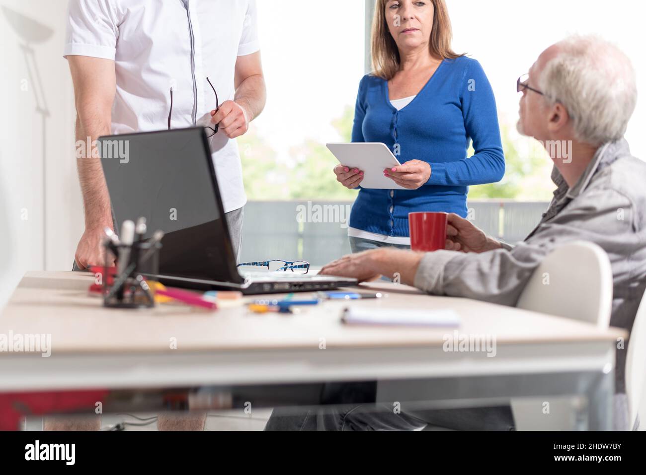 Coworkers having a business discussion in office Stock Photo - Alamy