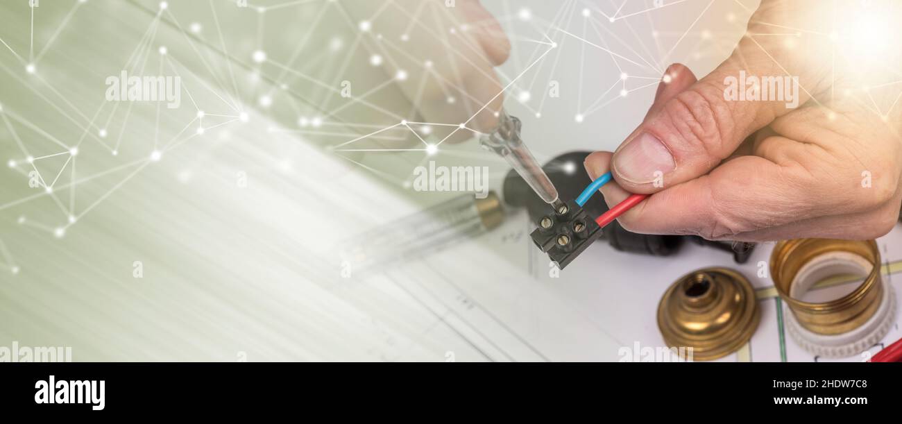 Clamping a wire in a connector; light effect Stock Photo - Alamy