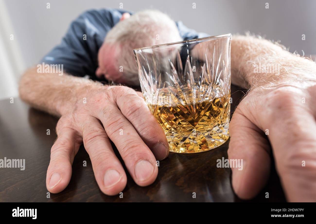 Slumped at table hi-res stock photography and images - Alamy