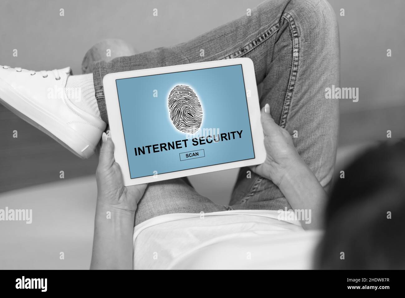 Woman looking at internet security concept on a tablet Stock Photo - Alamy