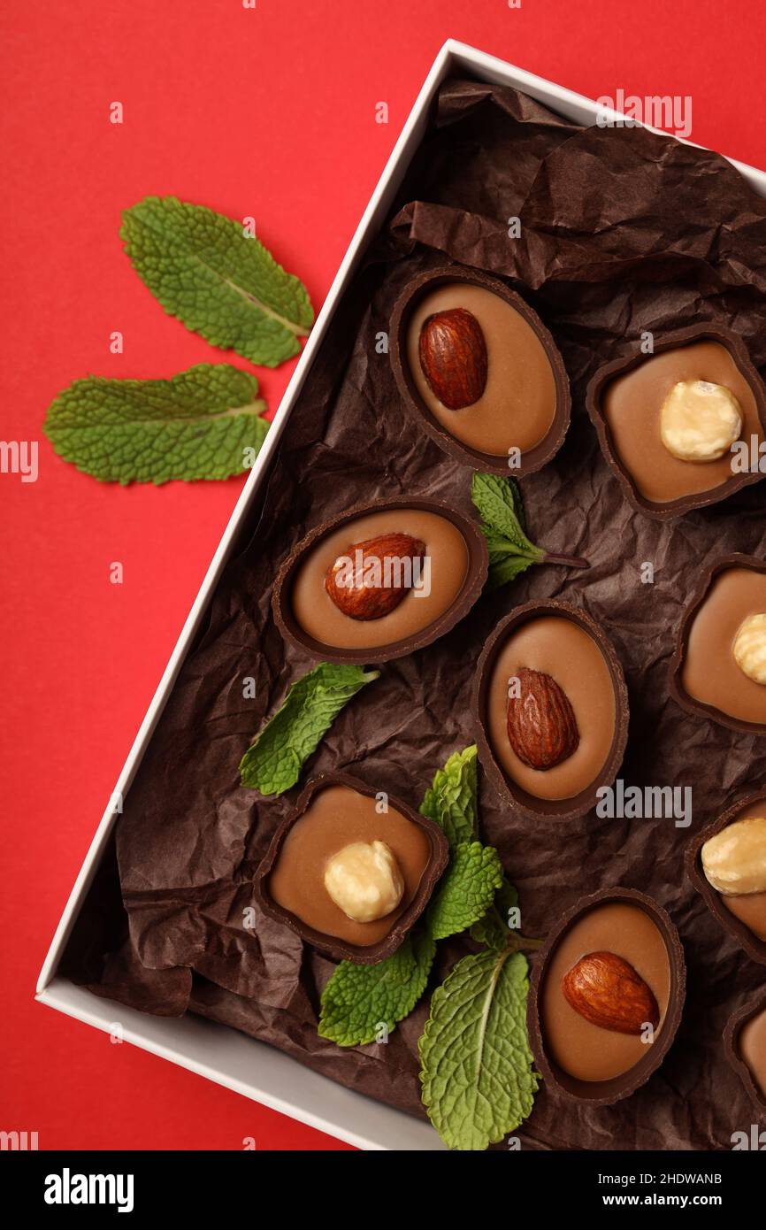 Concept of sweets with chocolate candies on red background Stock Photo ...