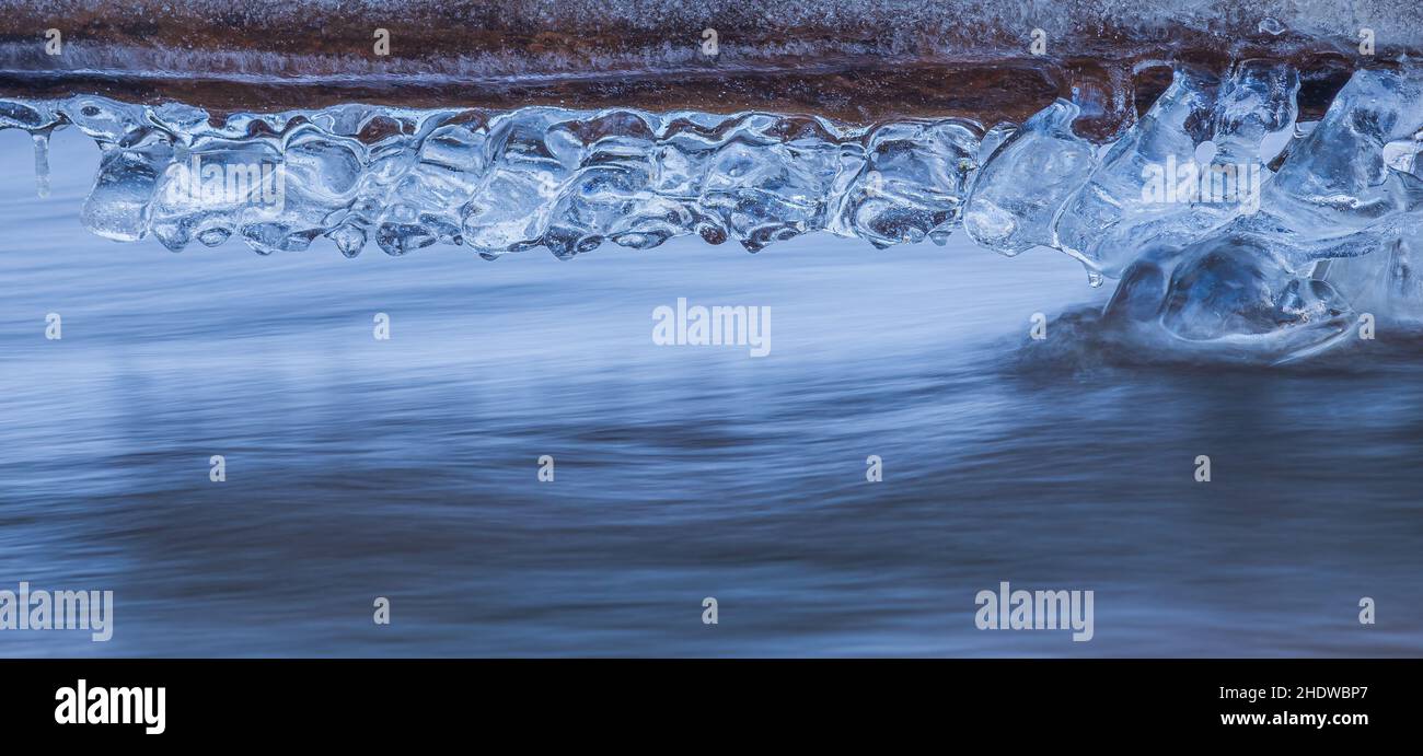 Icicles at winter, cold weather with icicles over river stream ...