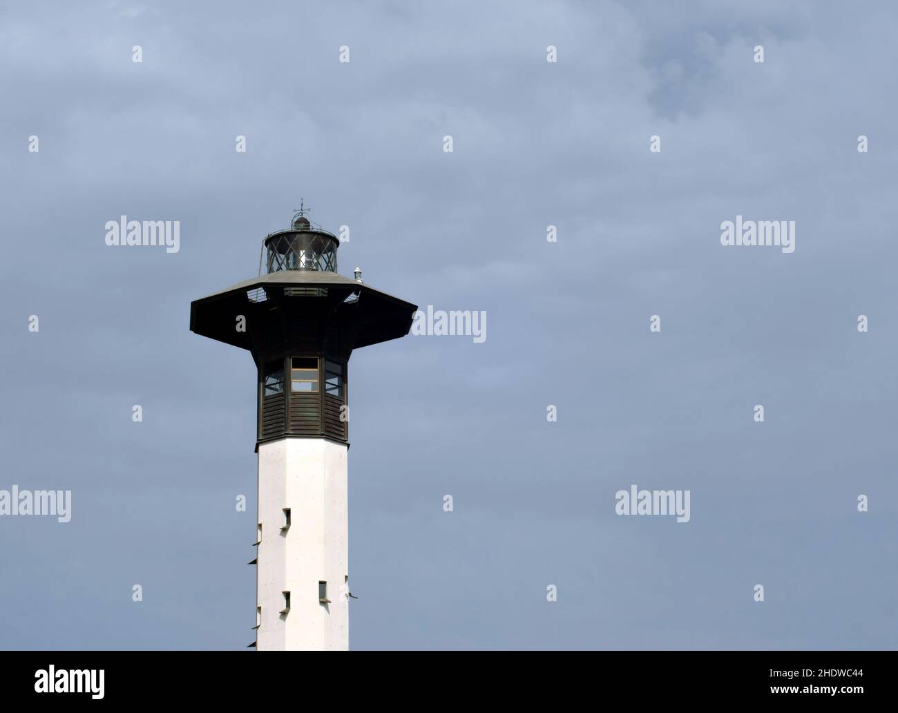 daytime photo of a lighthouse with many windows. cloudy day. stock ...