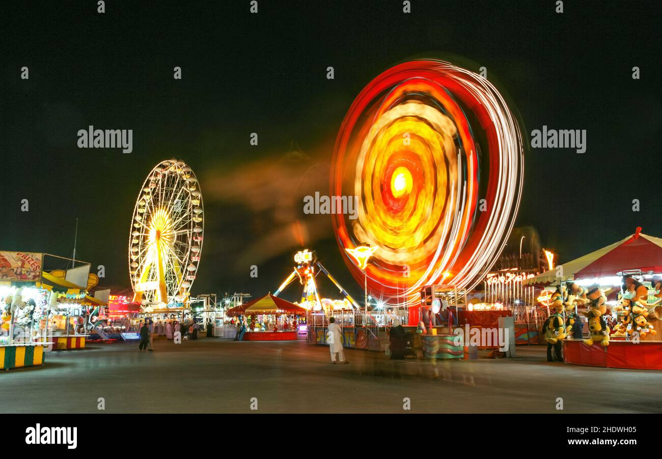 Night-time attractions at the fun-fair at Dubai Global Village in Dubai ...