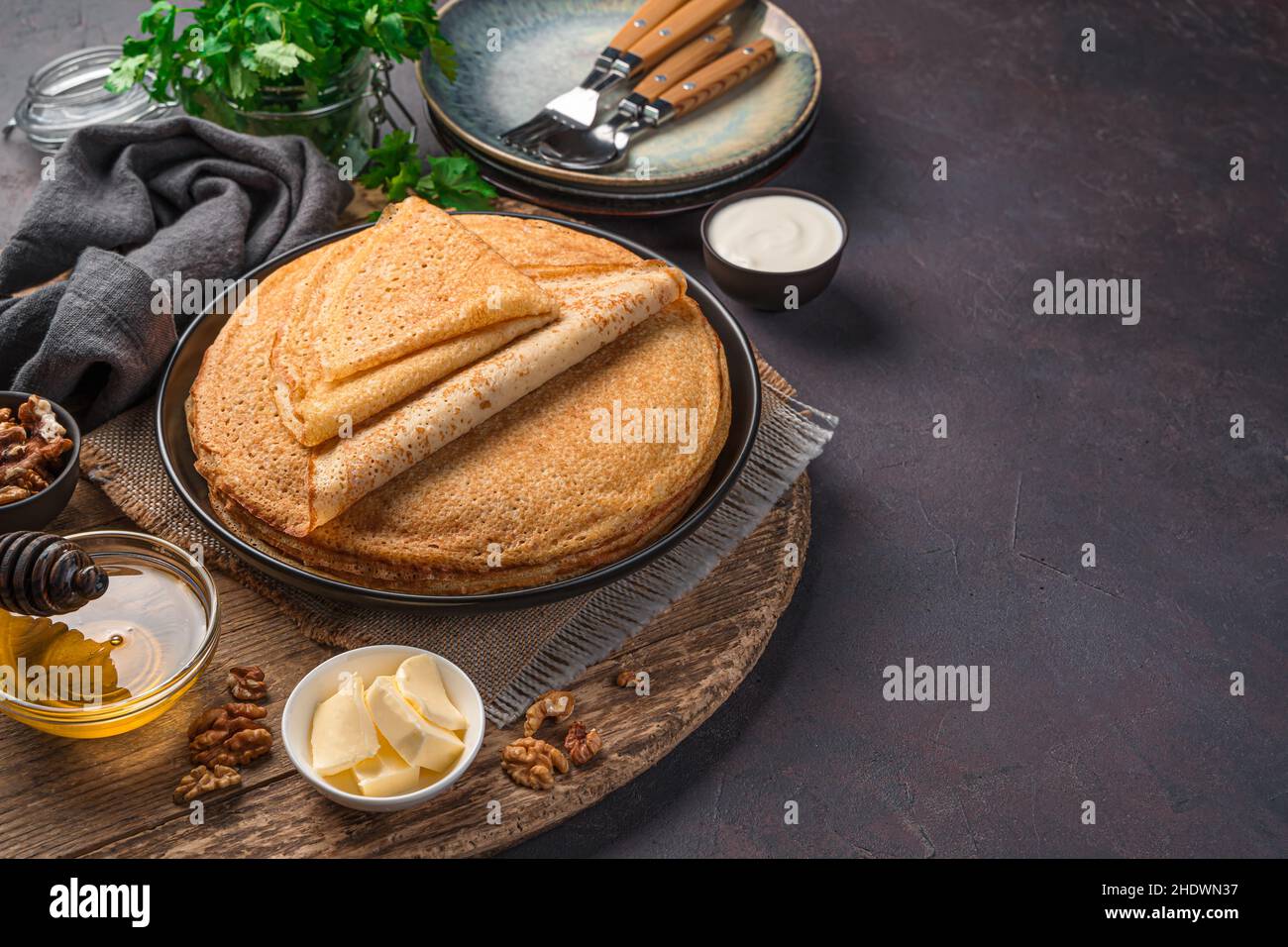 A stack of fried thin pancakes on a dark background. Pancake day. Side ...