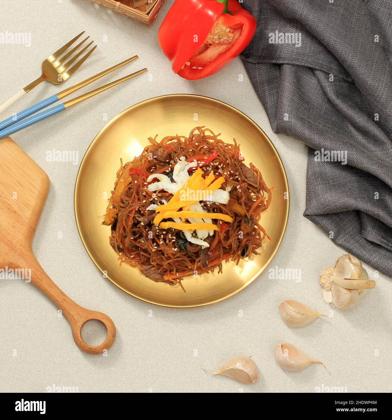 Japchae, Stir Fry Korean Glass Noodle on Golden Plate Stock Photo - Alamy