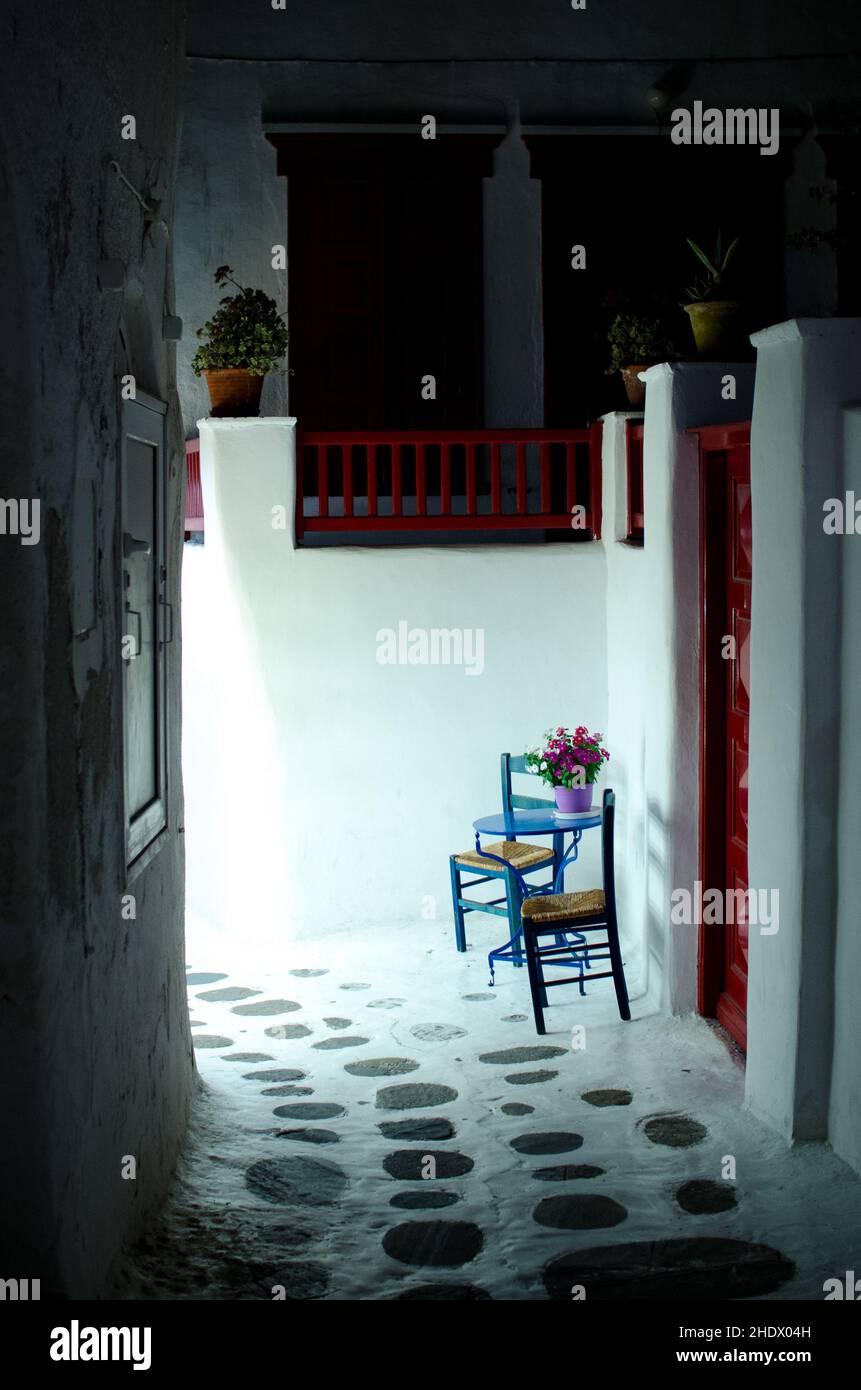 Vertical shot of a corner alley with dotted path walk in Mykonos ...