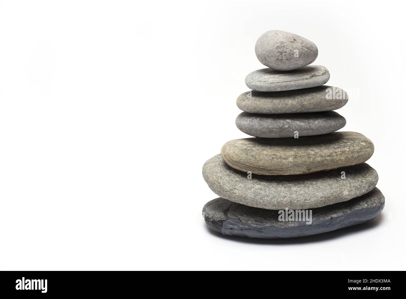 Close up of several different sized stones stacked on top of each other ...