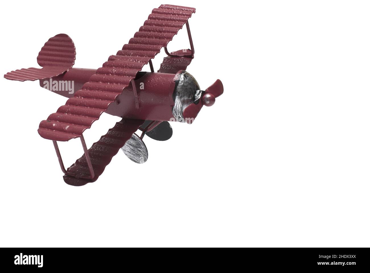 Close up of small red tin toy biplane airplane white background Stock ...