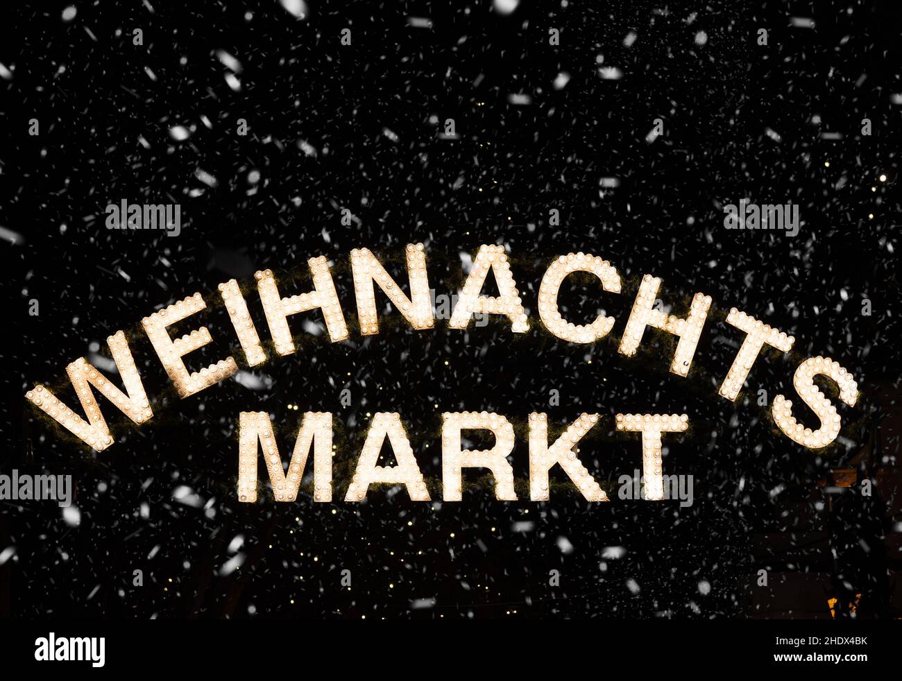 Illuminated Christmas Market sign in german under snowfall Stock Photo ...