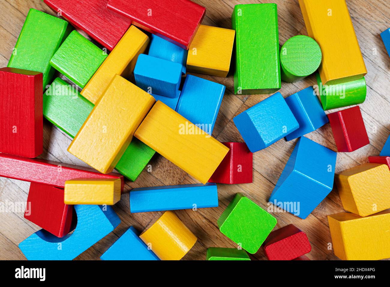 above view of colorful wooden toy blocks on hardwood floor Stock Photo ...