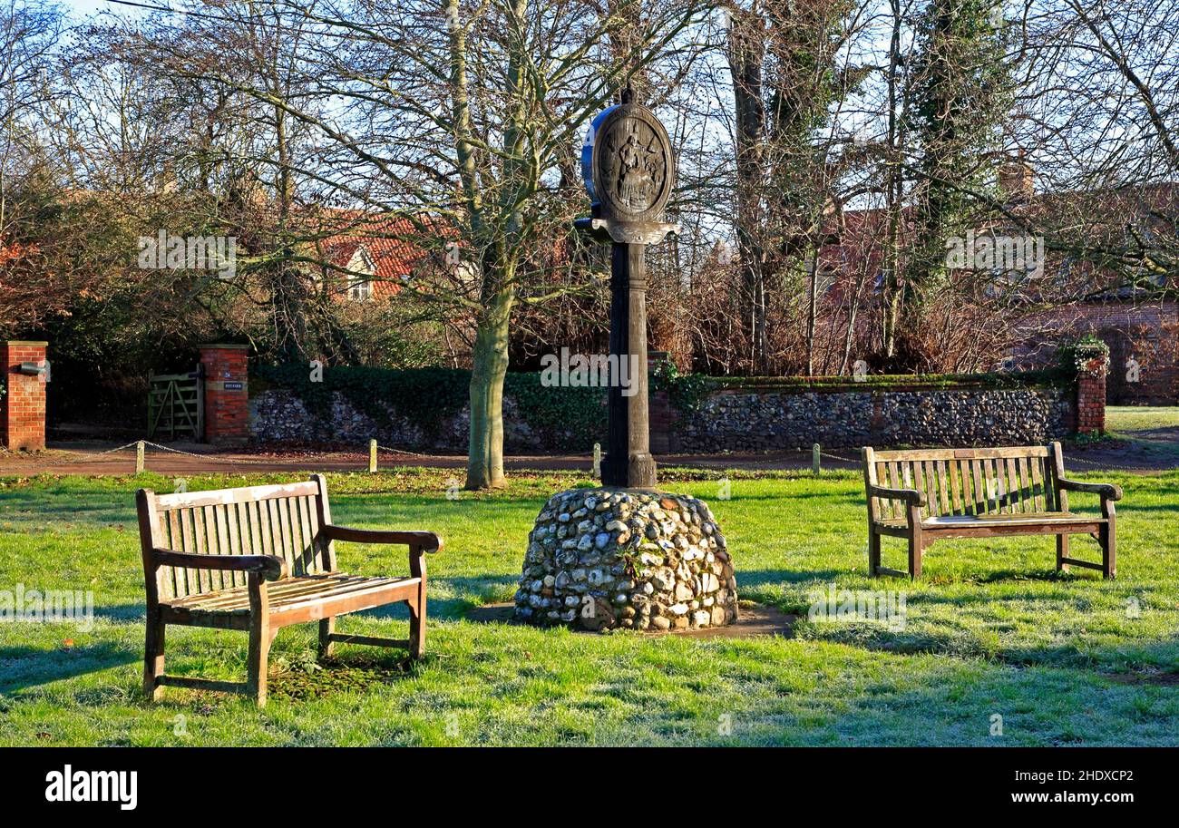 Village sign and bench seats on the village green in the Wensum Valley ...