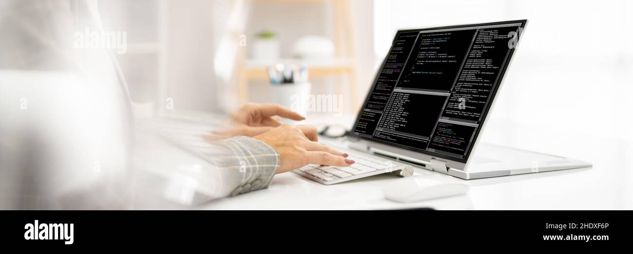 Programmer Or Coder At Office Desk Using Laptop Stock Photo - Alamy