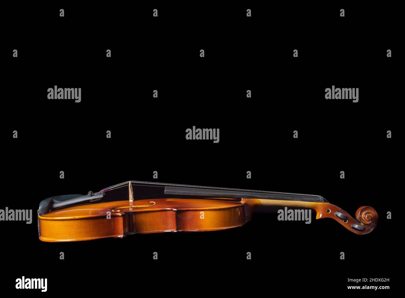 Side view of a violin lying on a black background. Copy space Stock ...