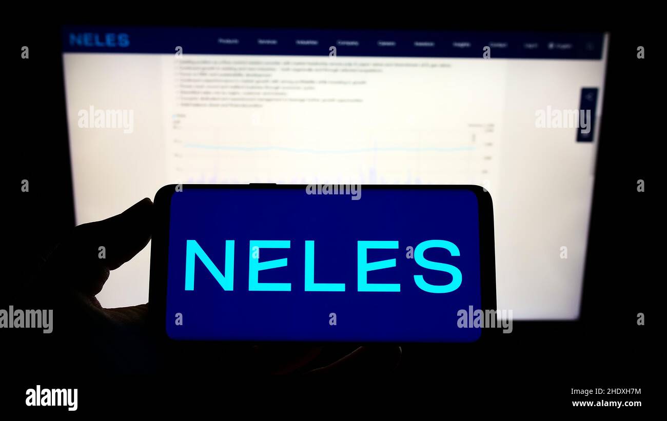 Person holding mobile phone with logo of Finnish flow control company ...