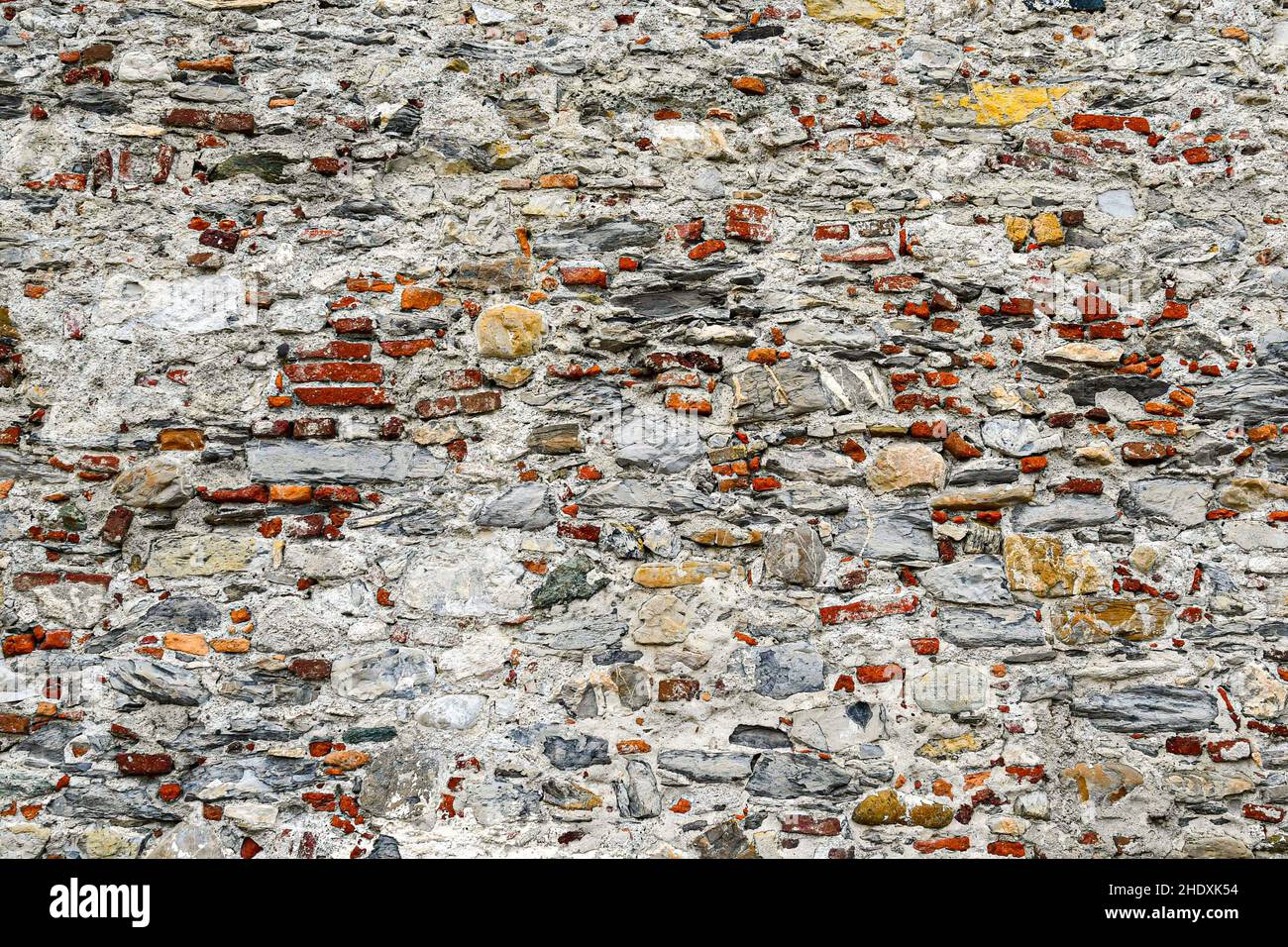 Close-up of an ancient stone and brick wall, with different textures ...