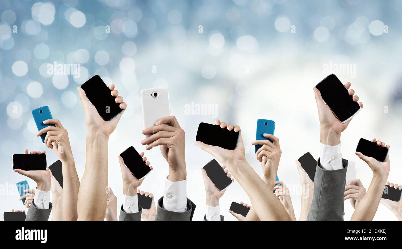 Hand holding phones crowd hi-res stock photography and images - Alamy