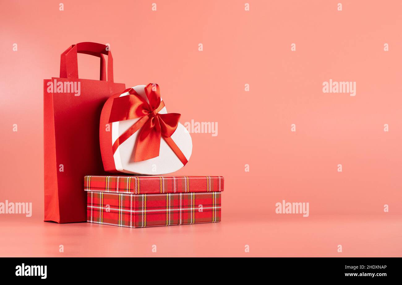 Bright packaging for purchases, gifts and parcels on a pink background ...