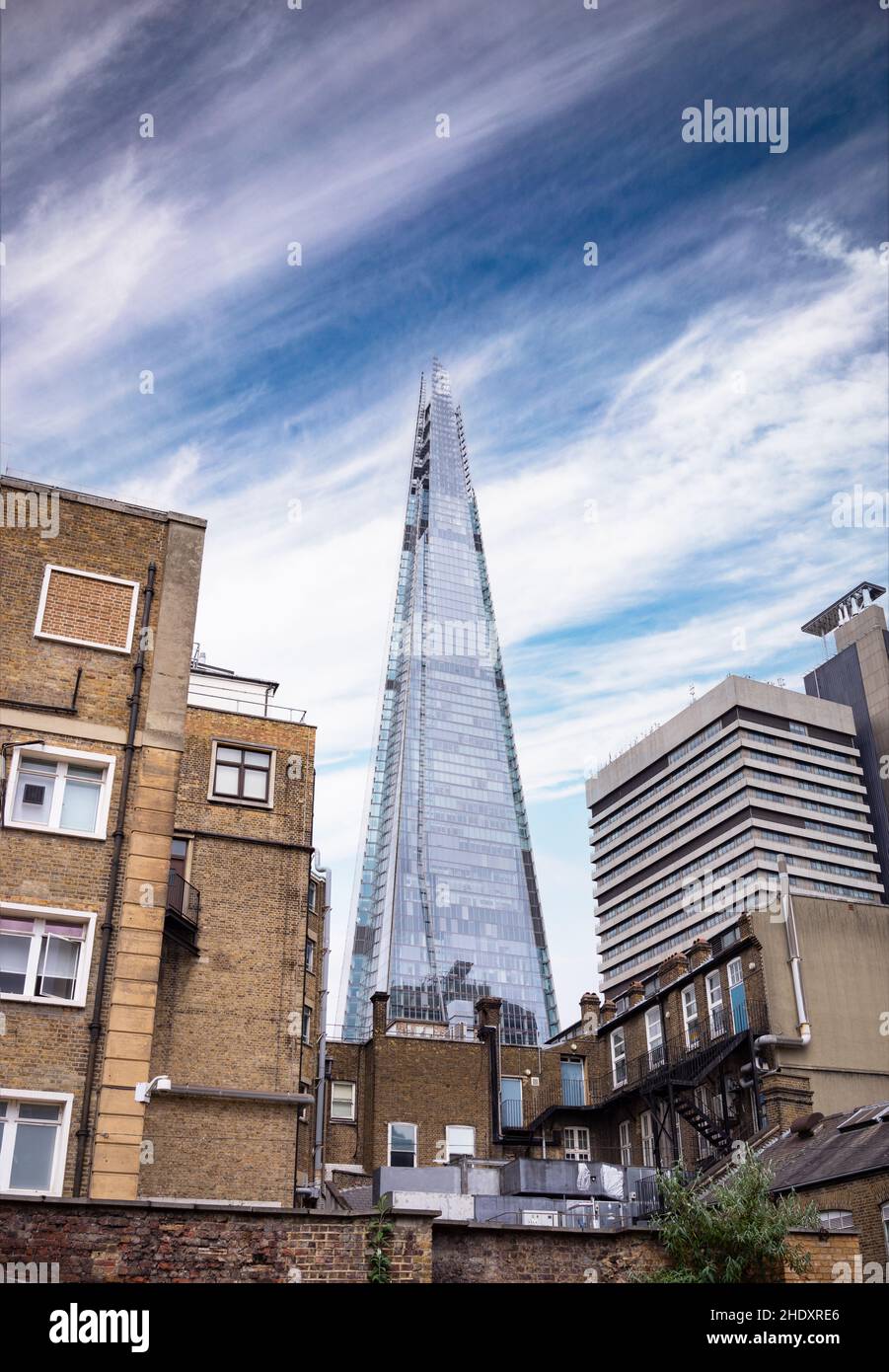 Street view in London of old buildings with the modern Shard building ...