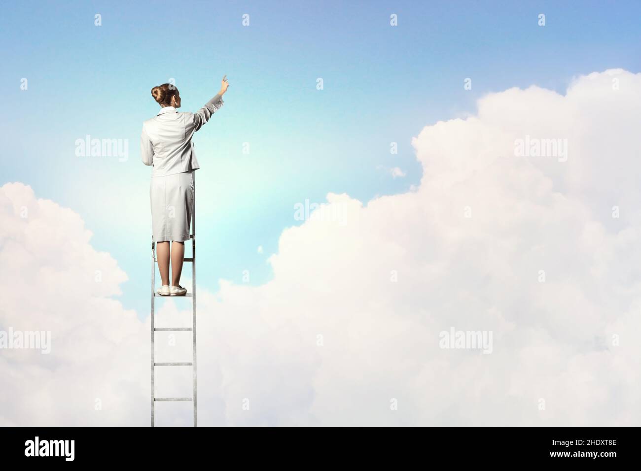 Woman reaching ladder rear view hi-res stock photography and images - Alamy