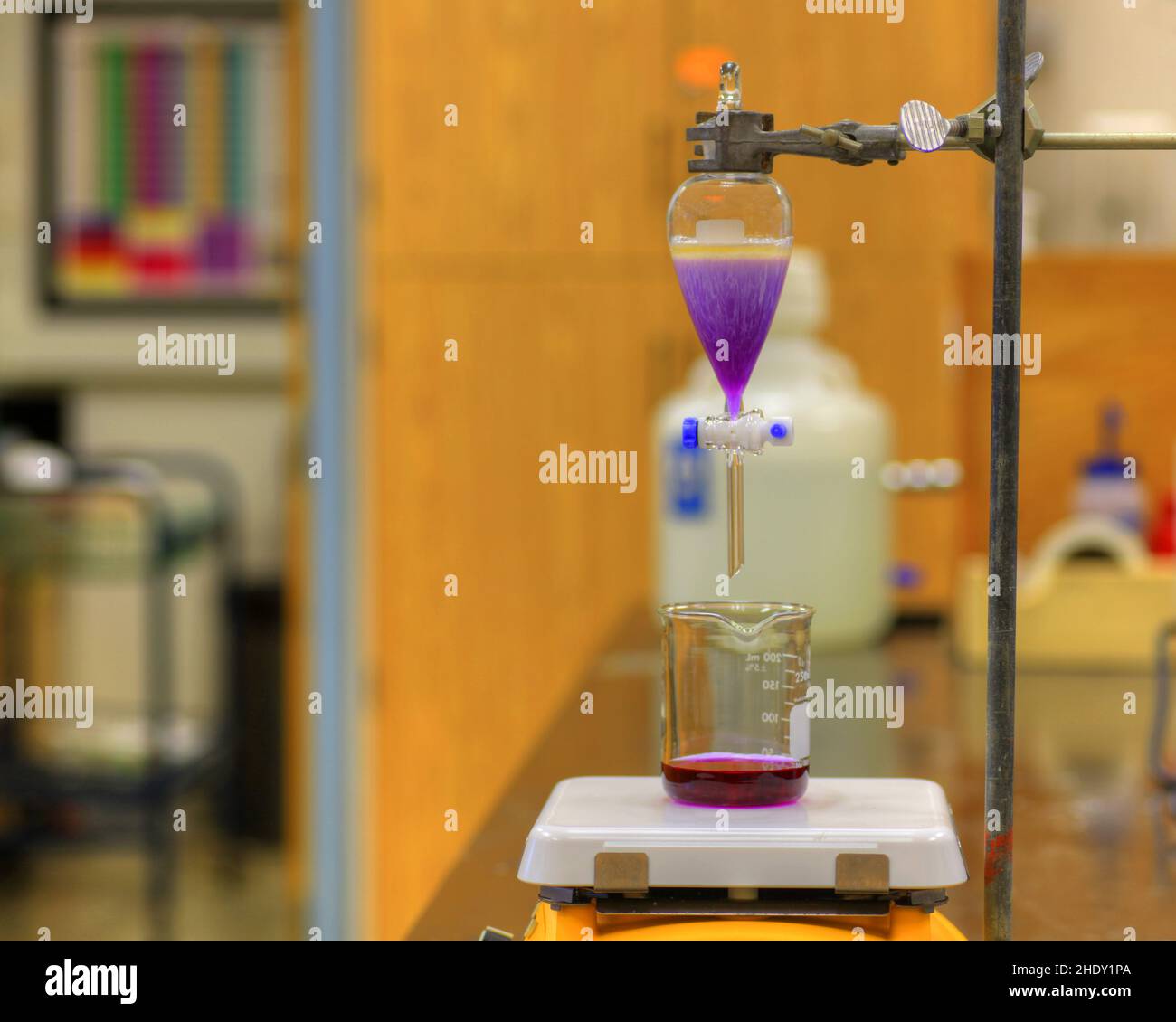 Two chemical phases being separated in a funnel Stock Photo - Alamy