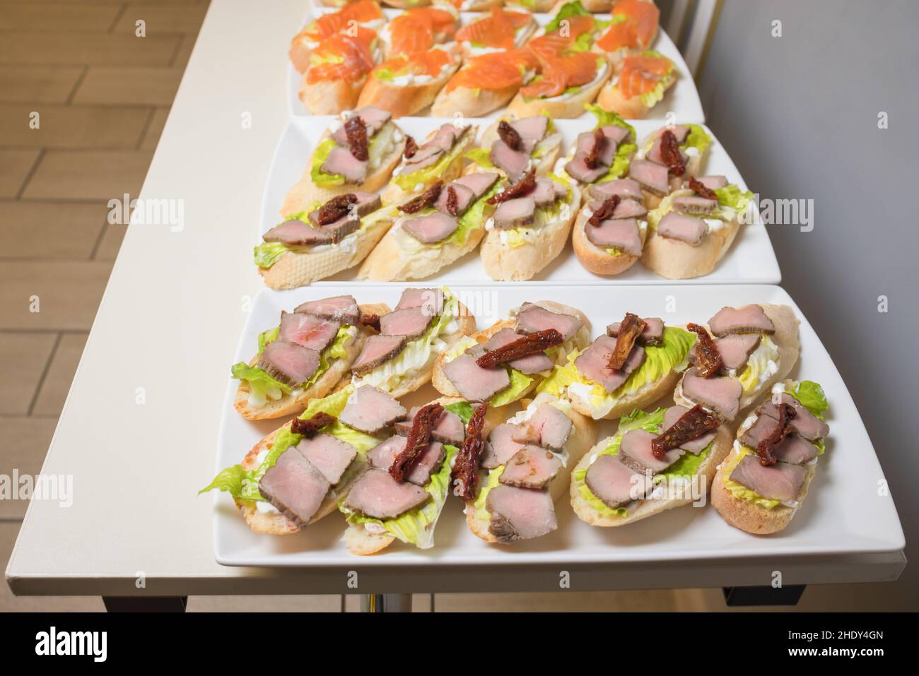 Plate of many mini bite size sandwich appetizers Stock Photo - Alamy