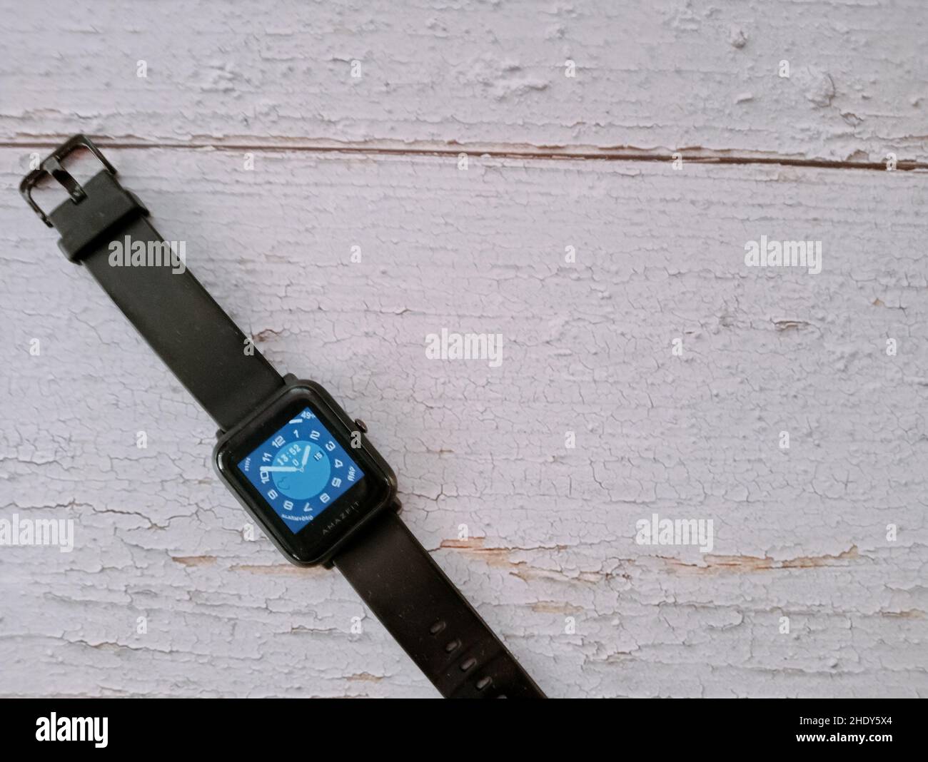 A smart watch in a wooden surface. Watch placed in bottom-left corner of the screen Stock Photo ...